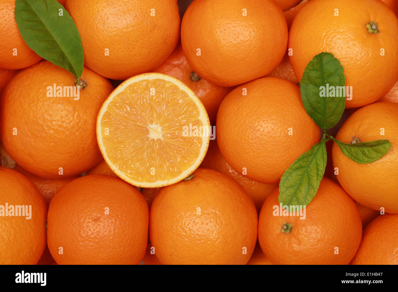 Group of many oranges with leaves forming a background Stock Photo - Alamy