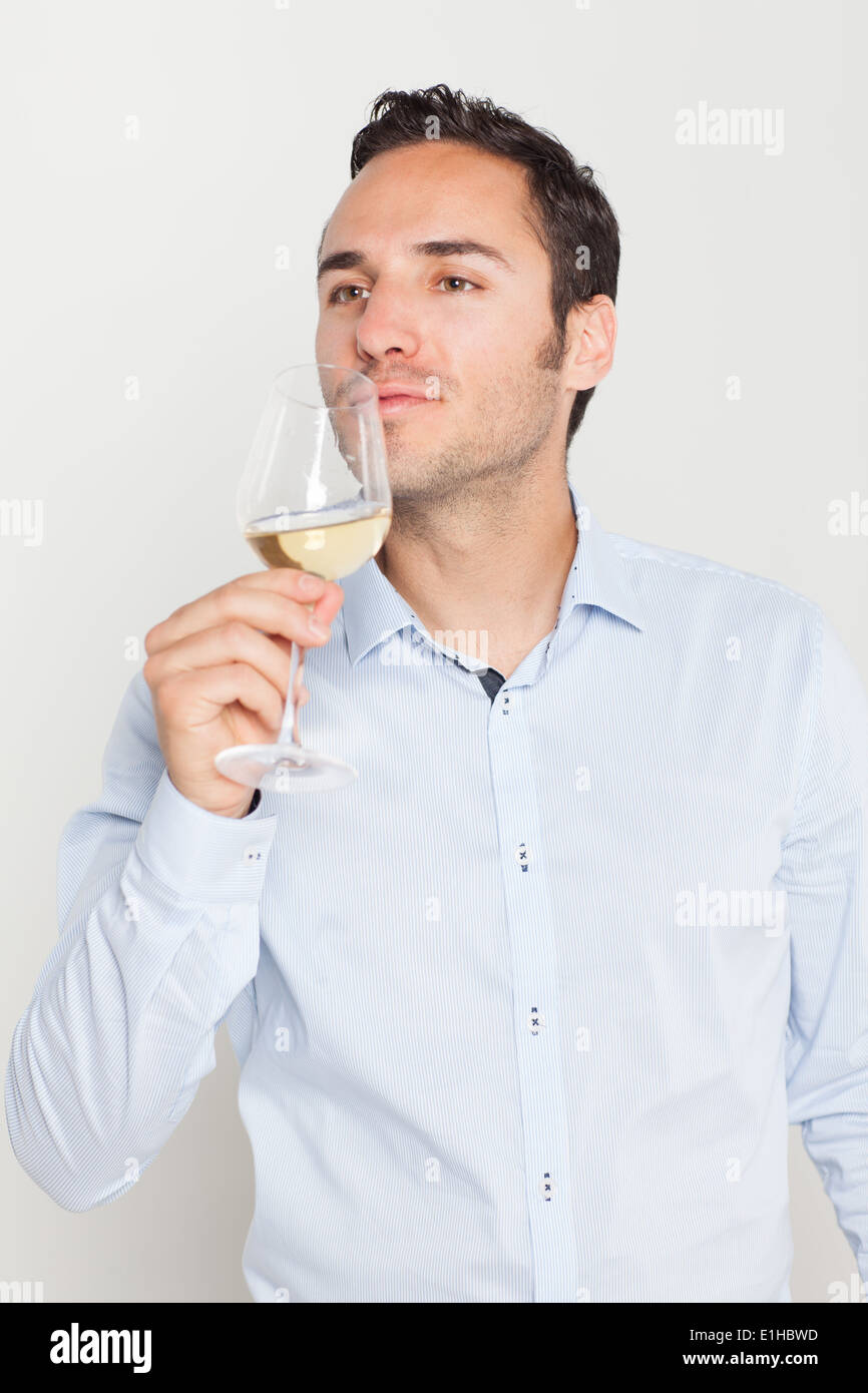 Man drinking a glass of white wine Stock Photo - Alamy