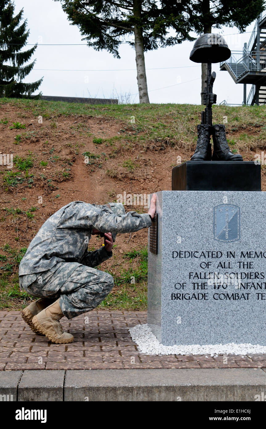 A soldier with 170th Infantry Brigade Combat Team pays his respects ...