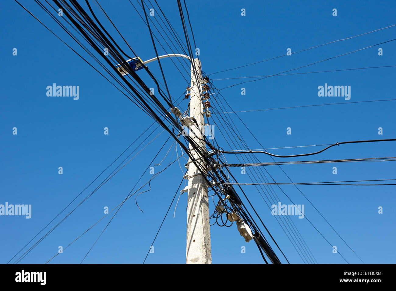 Mess of electric cables and telephone wires hi-res stock photography ...