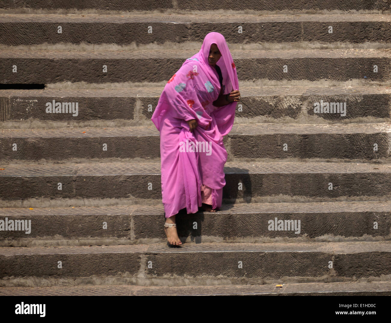 Lady in sari descending on stone steps Stock Photo - Alamy