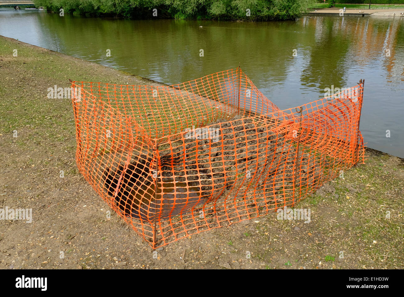 waterlogged hole in the ground cordoned off Stock Photo - Alamy