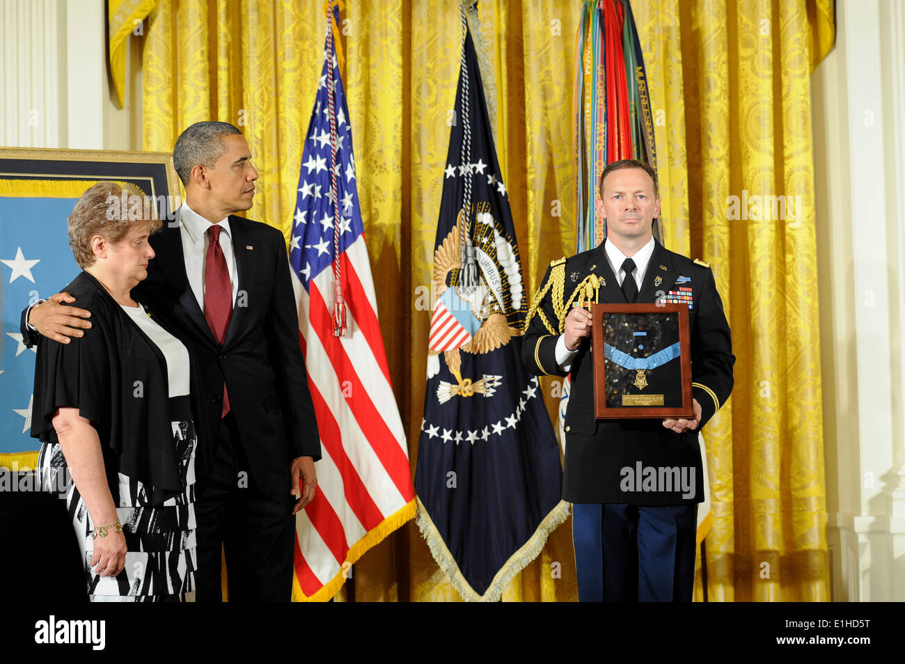 President Barack Obama, center, offers comfort to Rose Buccelli, the ...