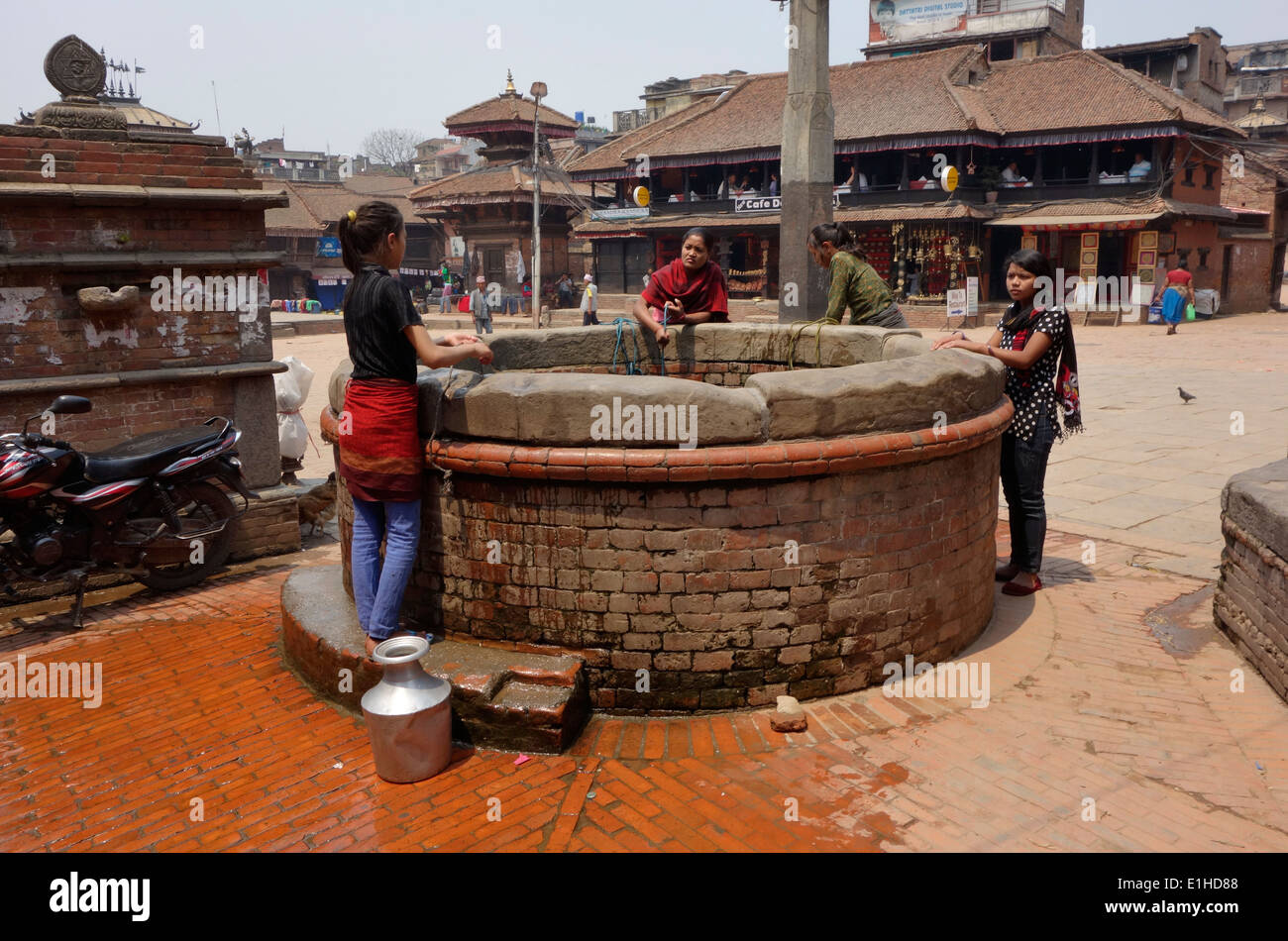 Getting water at the public well Stock Photo - Alamy