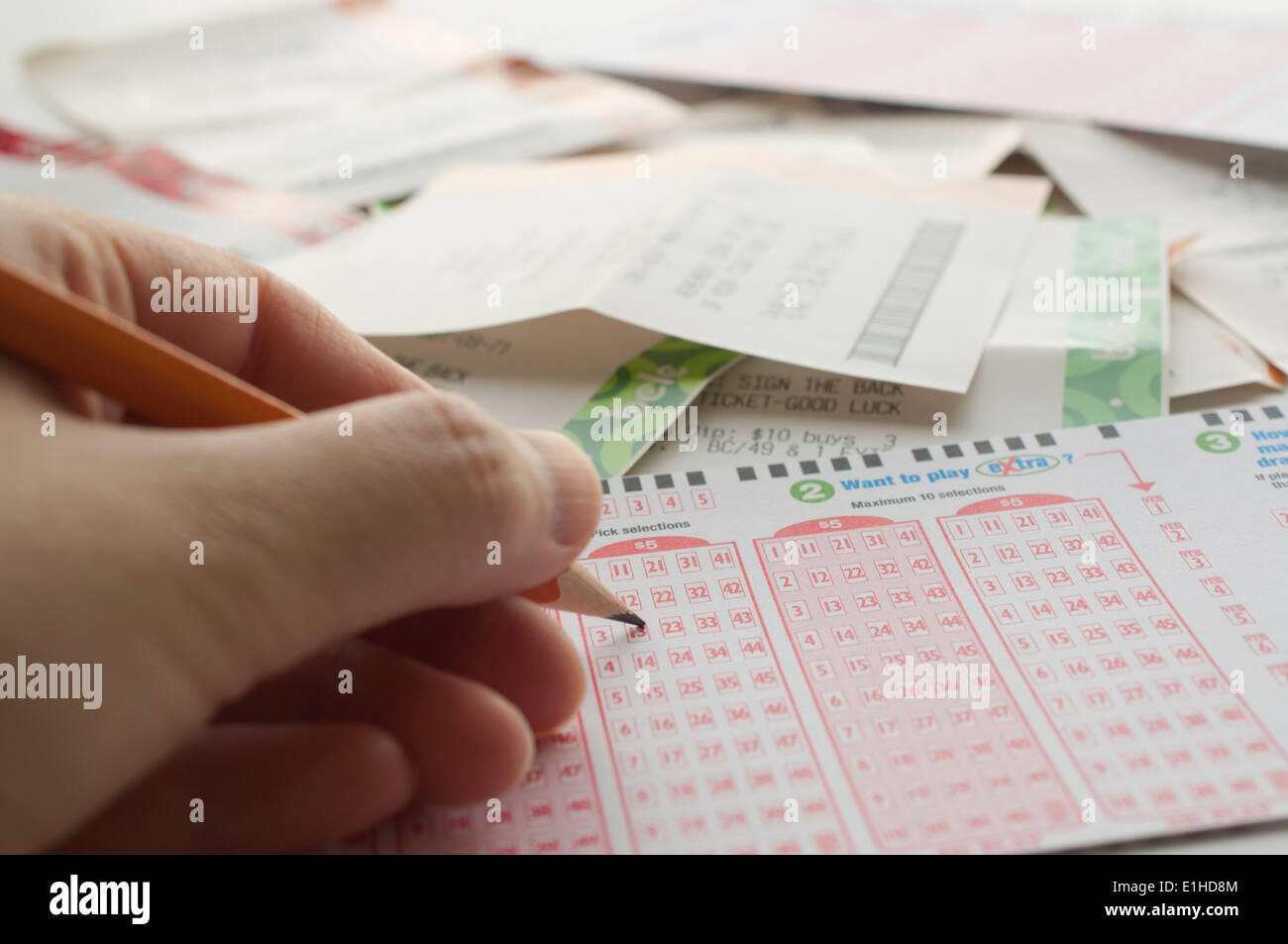Person marking number on lottery ticket Stock Photo - Alamy