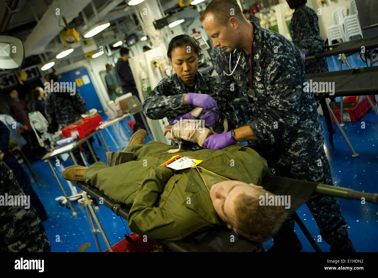 U.S. Navy corpsmen triage a simulated patient during a mass casualty ...