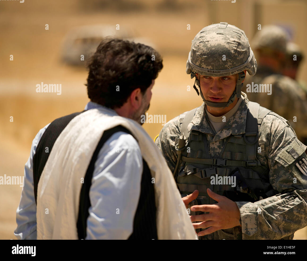 A U.S. Army soldier speaks with a role player while participating in a ...