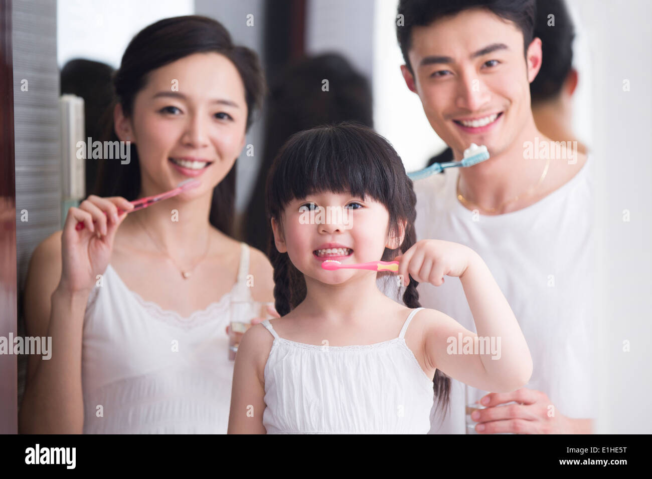 Happy family brushing teeth Stock Photo - Alamy