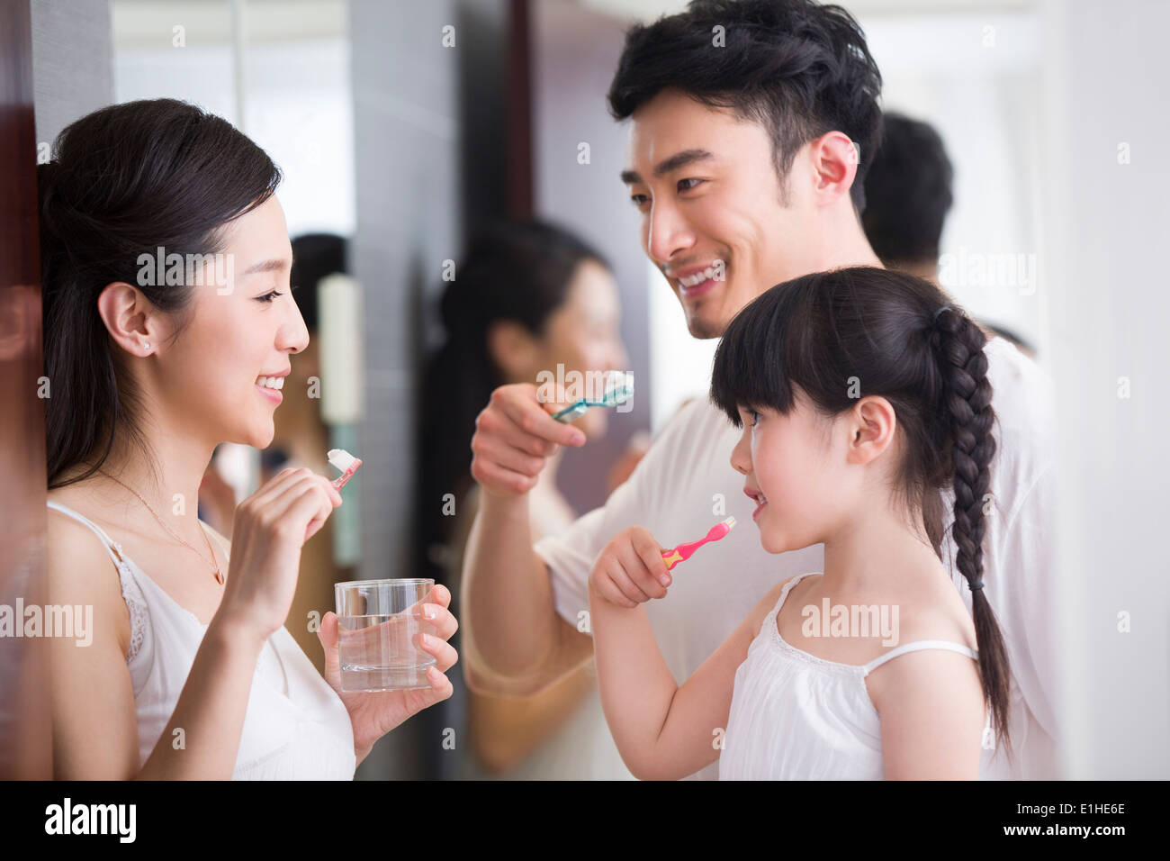 Happy family brushing teeth Stock Photo - Alamy