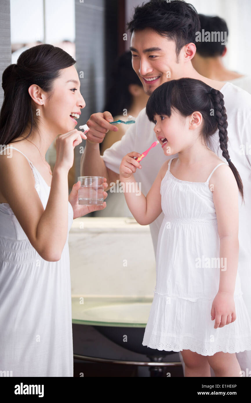 Happy family brushing teeth Stock Photo - Alamy