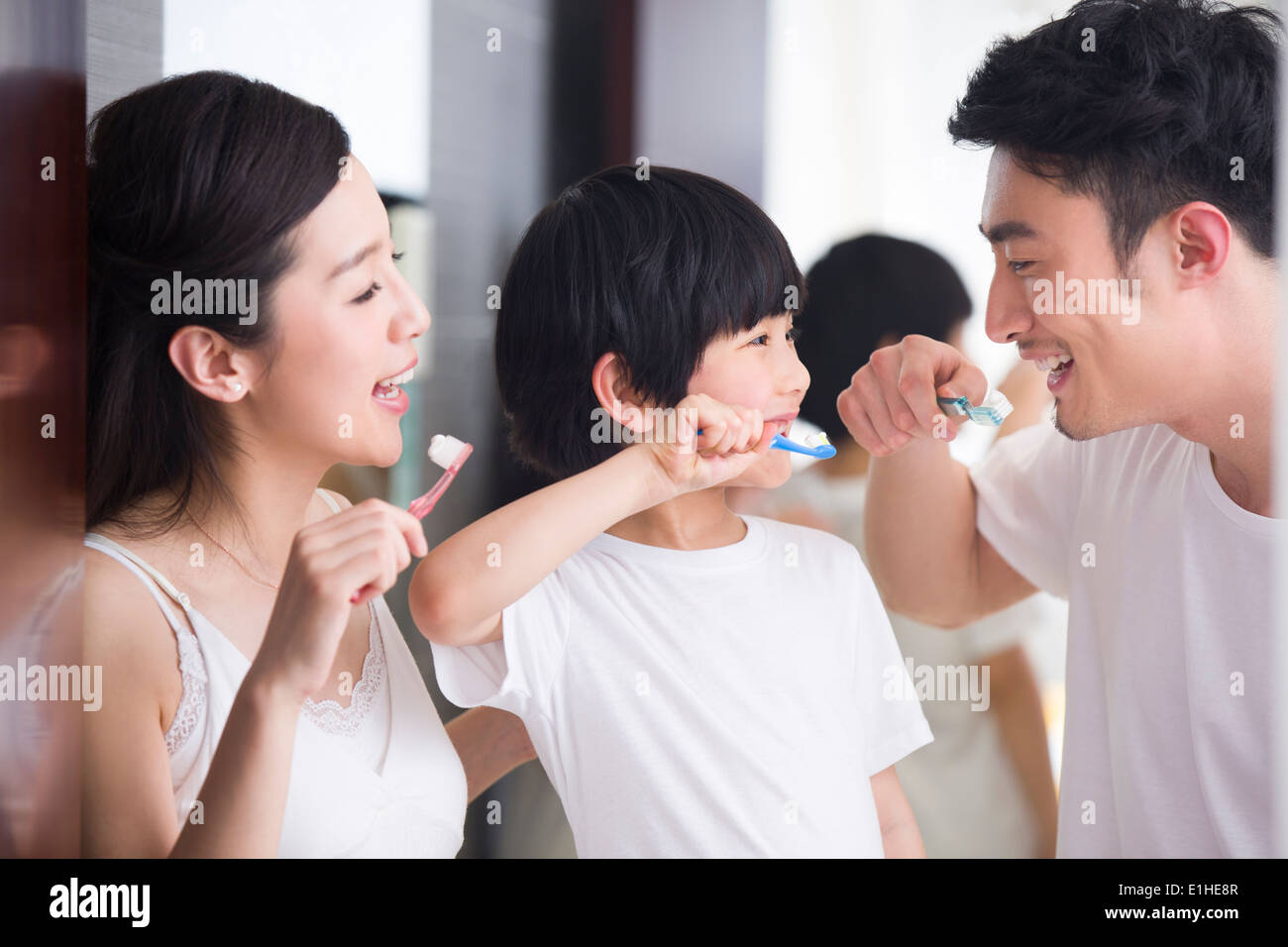 Happy family brushing teeth Stock Photo - Alamy