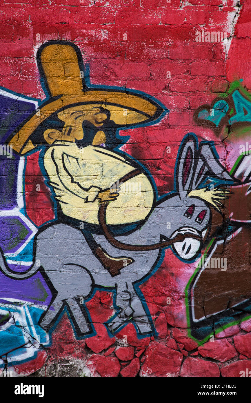 Urban art depicting a fat Mexican man riding a donkey or burro in the ...