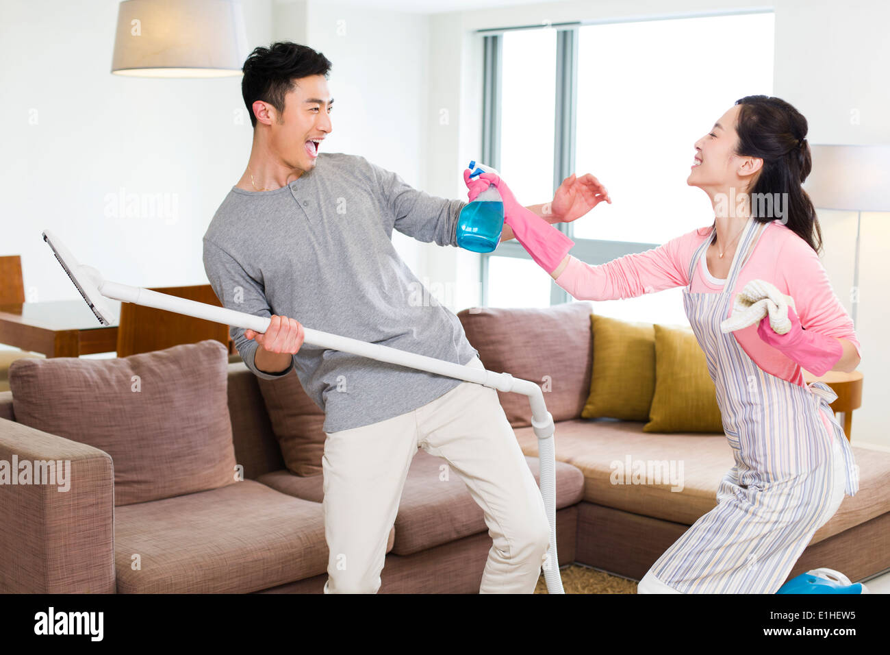 Young couple doing chores at home Stock Photo - Alamy