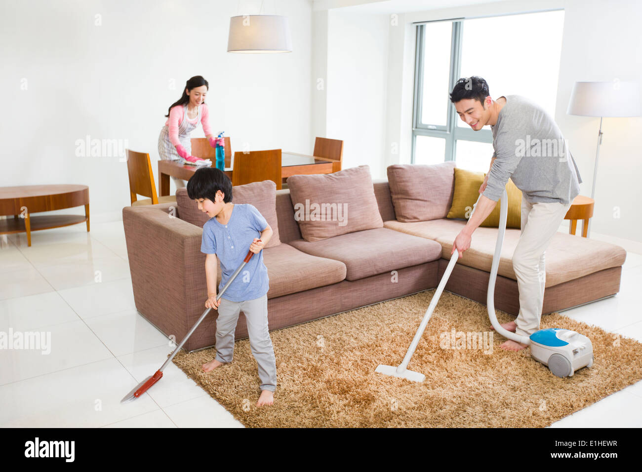 Young couple doing chores at home Stock Photo - Alamy