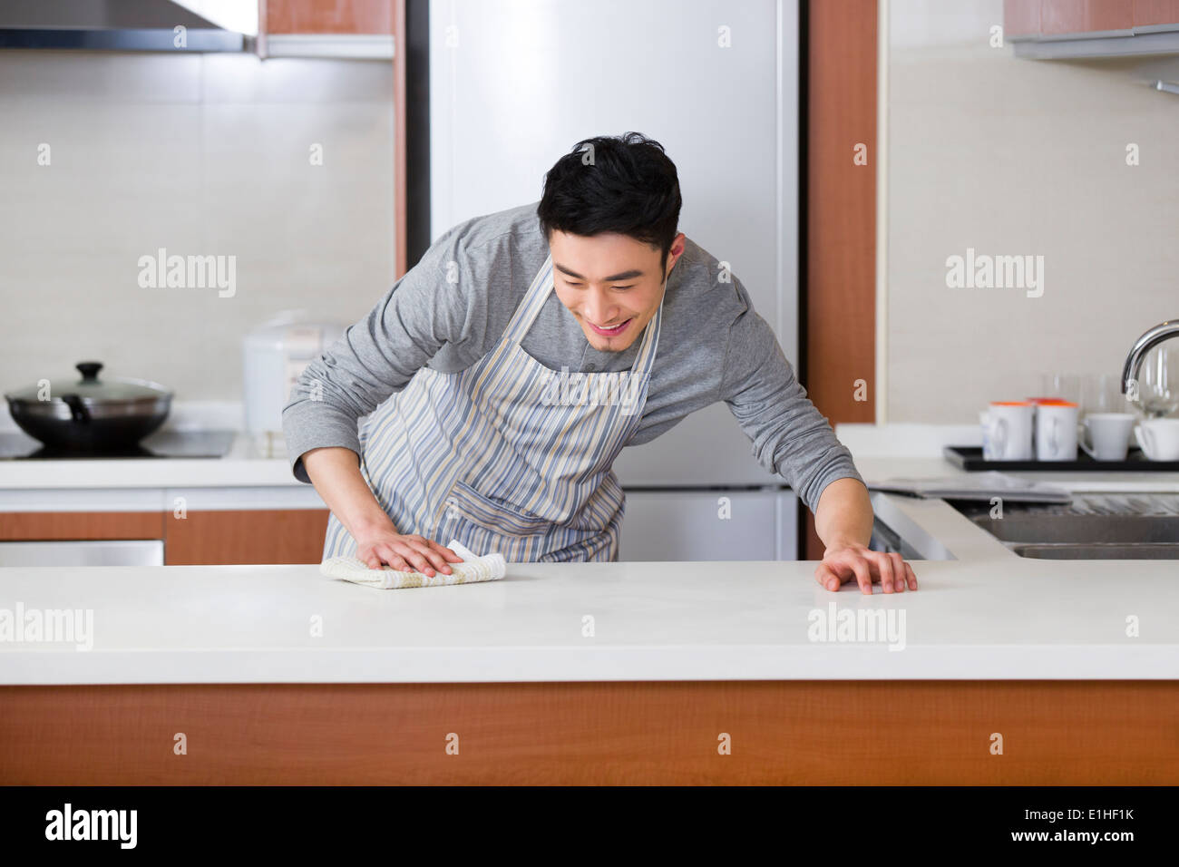 Three young people cleaning house hi-res stock photography and images ...