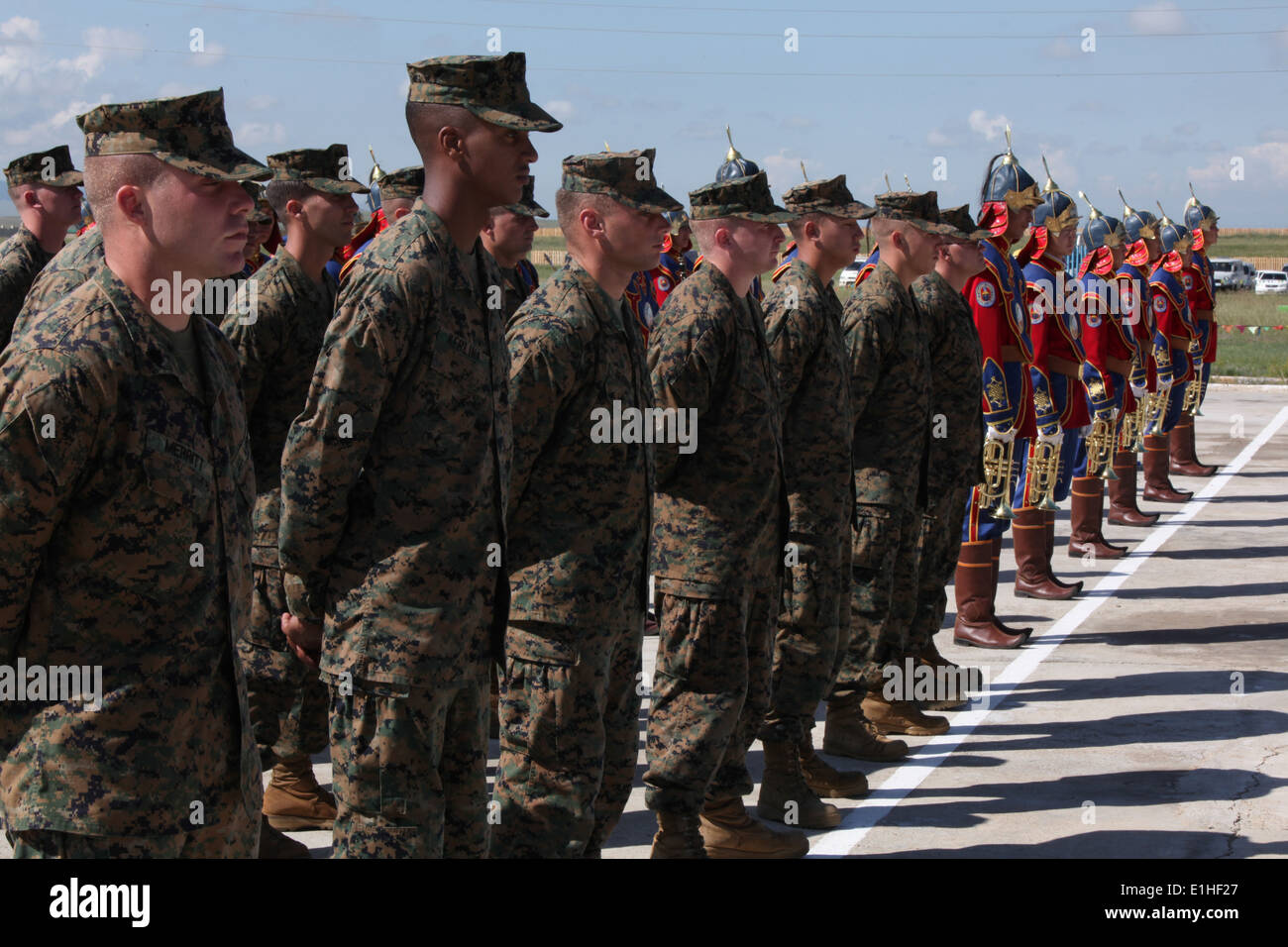 U.S. Marines stand in formation next to the Mongolian Armed Forces band ...