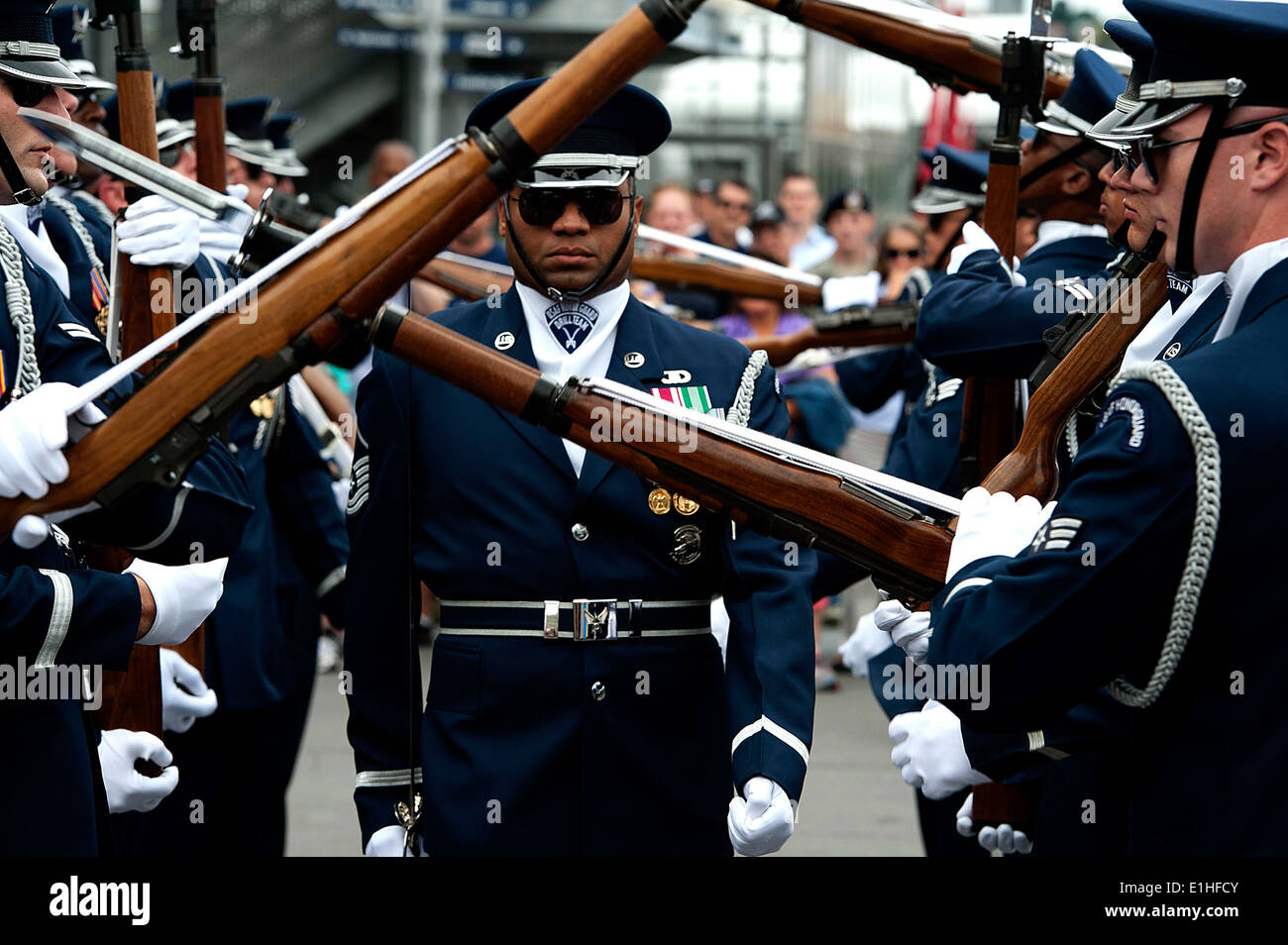 A member of the Air Force Drill Team walks through twirling rifles ...