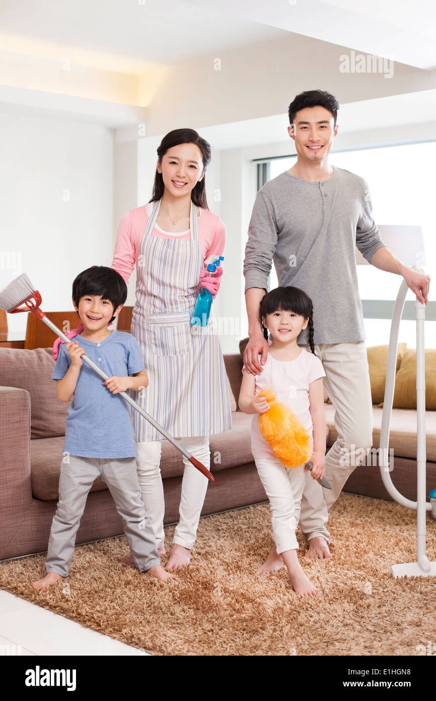 Cheerful family doing chores at home Stock Photo - Alamy