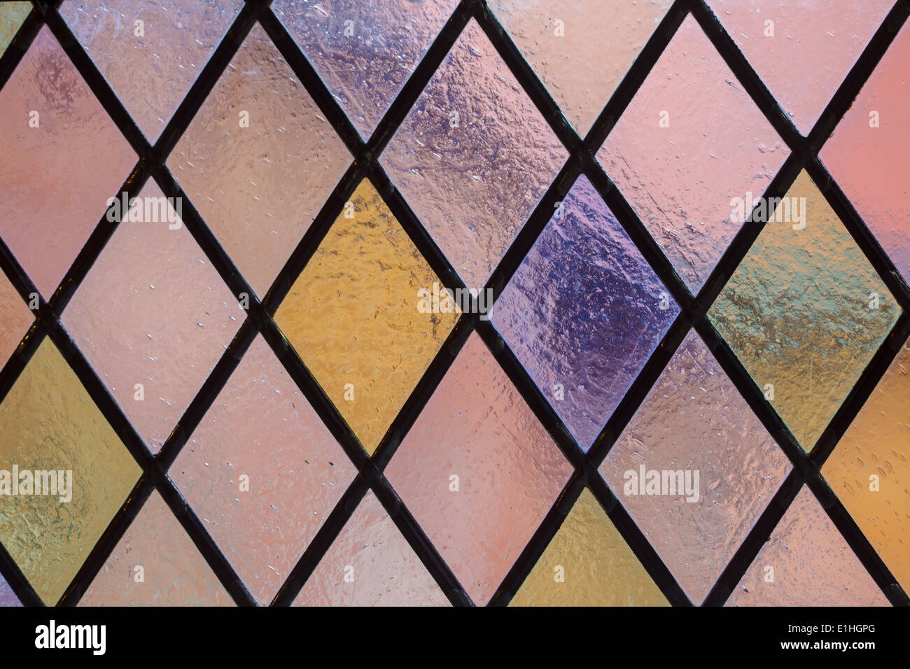 Stained glass with multi colored diamond pattern as background pink ...