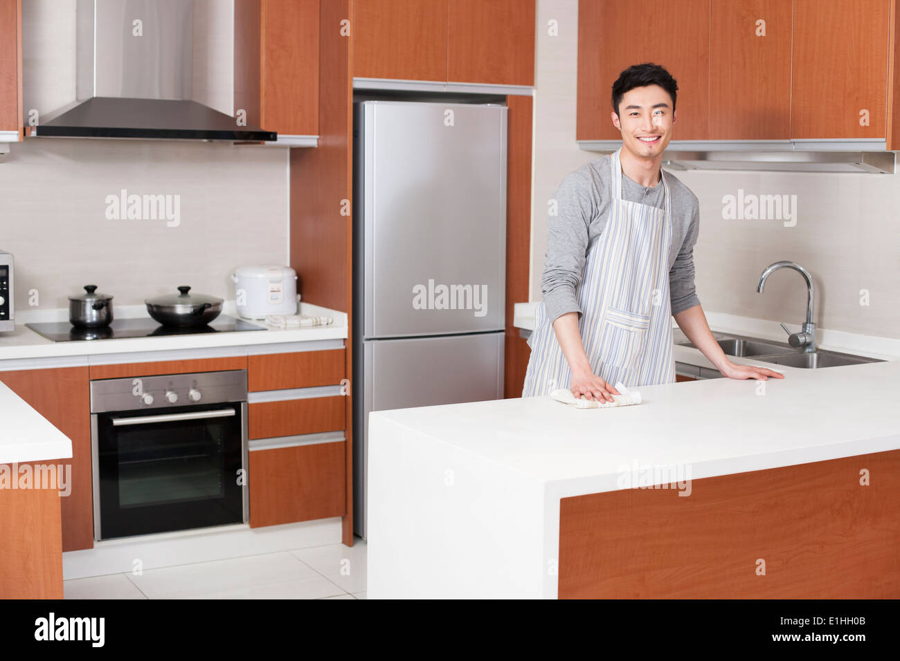 Young man cleaning kitchen hi-res stock photography and images - Alamy