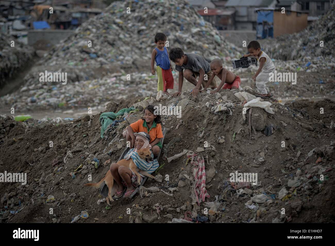 Paranaque, Philippines. 5th June, 2014. Children play along a slope at ...