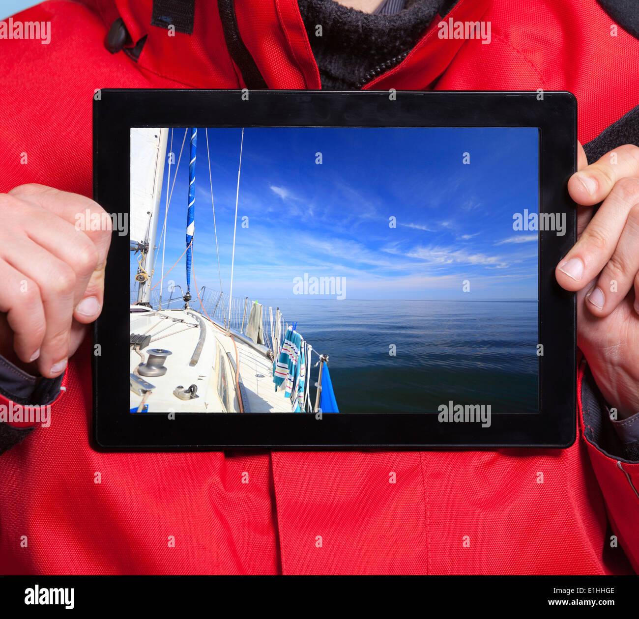 Man sailor showing tablet. Sailing Stock Photo - Alamy