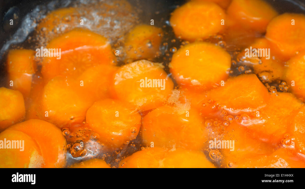 carrots boiling in a pan england uk Stock Photo - Alamy