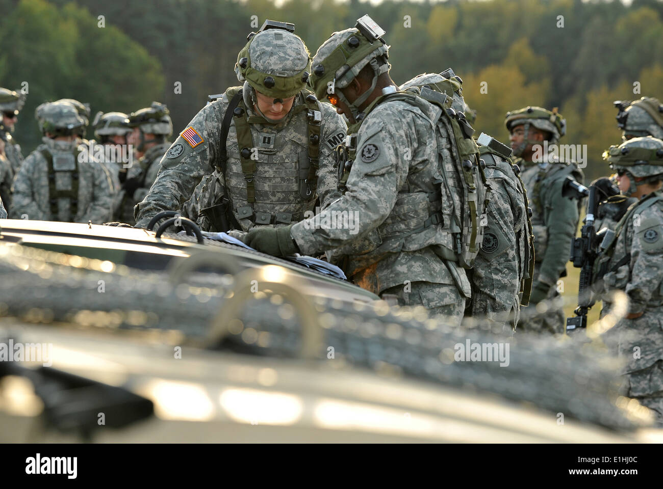 U.S. Soldiers with the 2nd Cavalry Regiment study a map in preparation ...