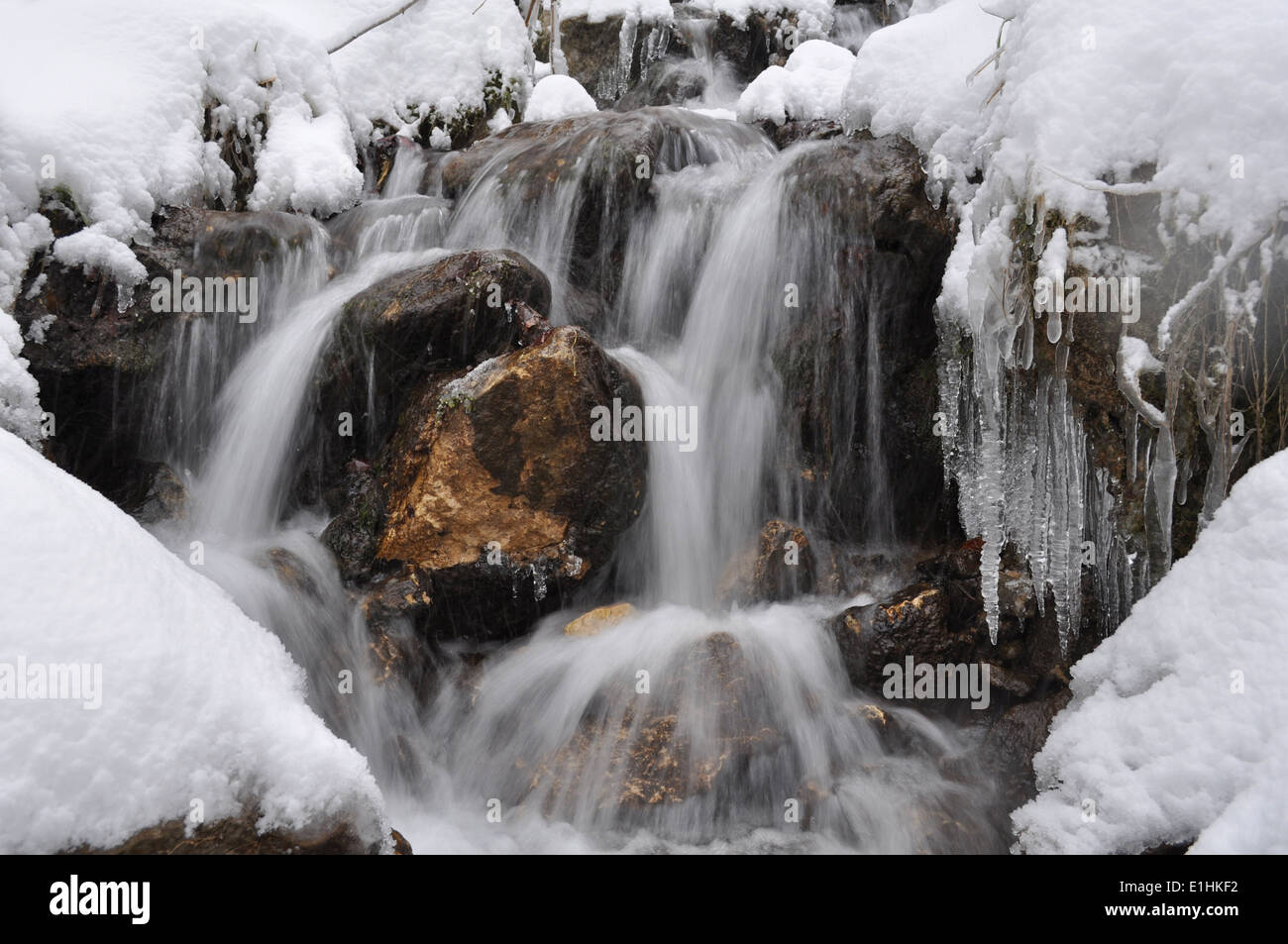 Waterfall and needle ice in the mountain Stock Photo - Alamy