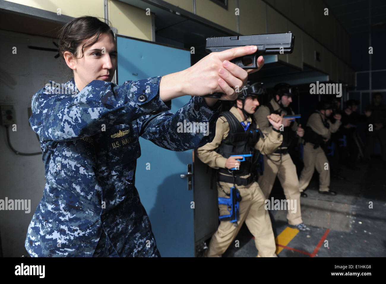 U.S. Coast Guard Lt. Kim Manuel, left, participates in a small-arms ...