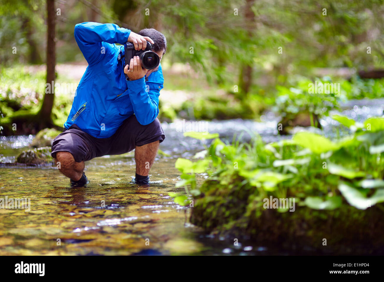 Professional nature photographer taking photos by the river side Stock ...