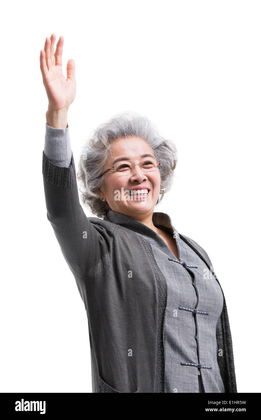 Happy senior woman waving Stock Photo - Alamy