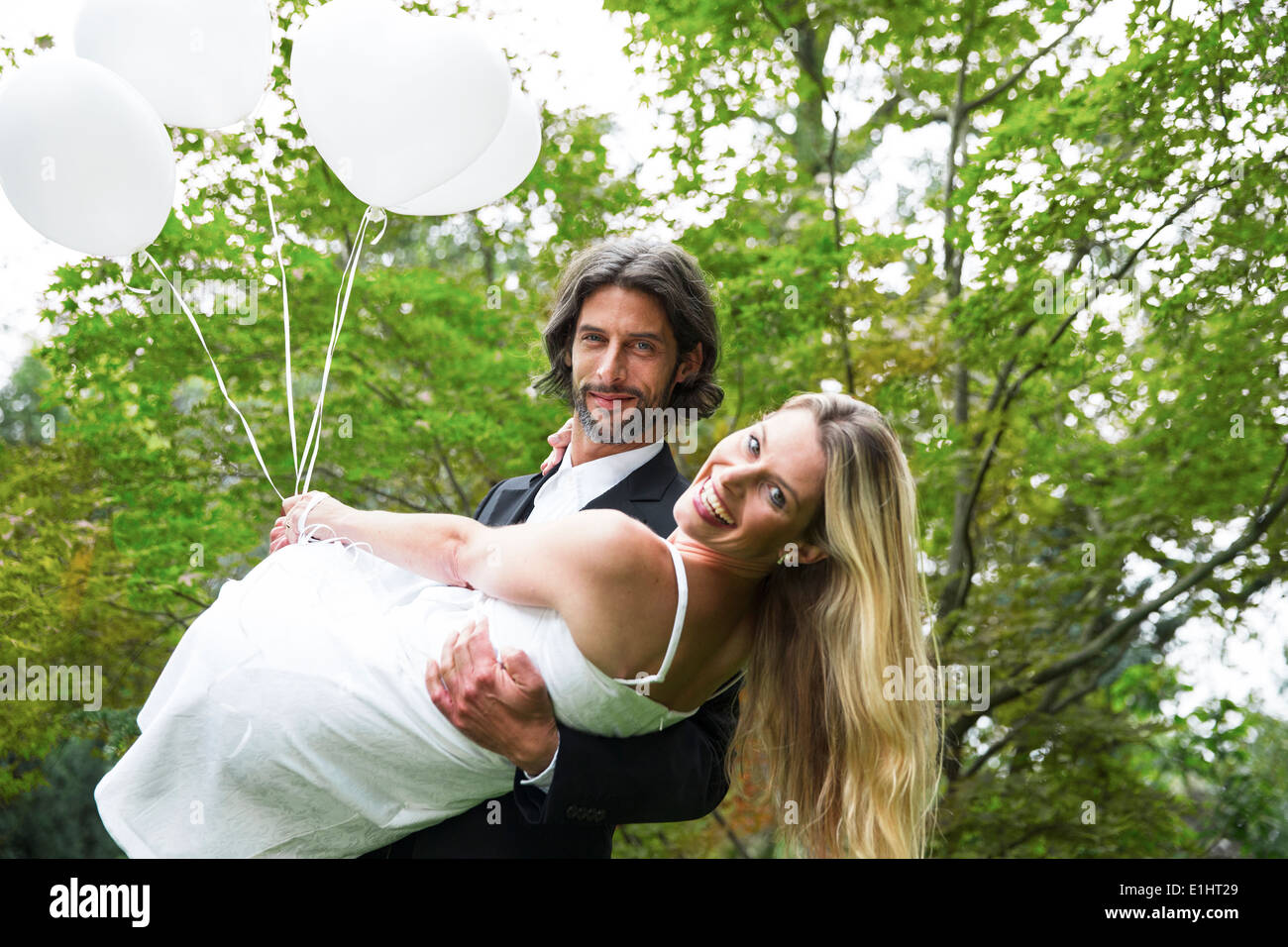 Newly married couple groom carrying hi-res stock photography and images ...