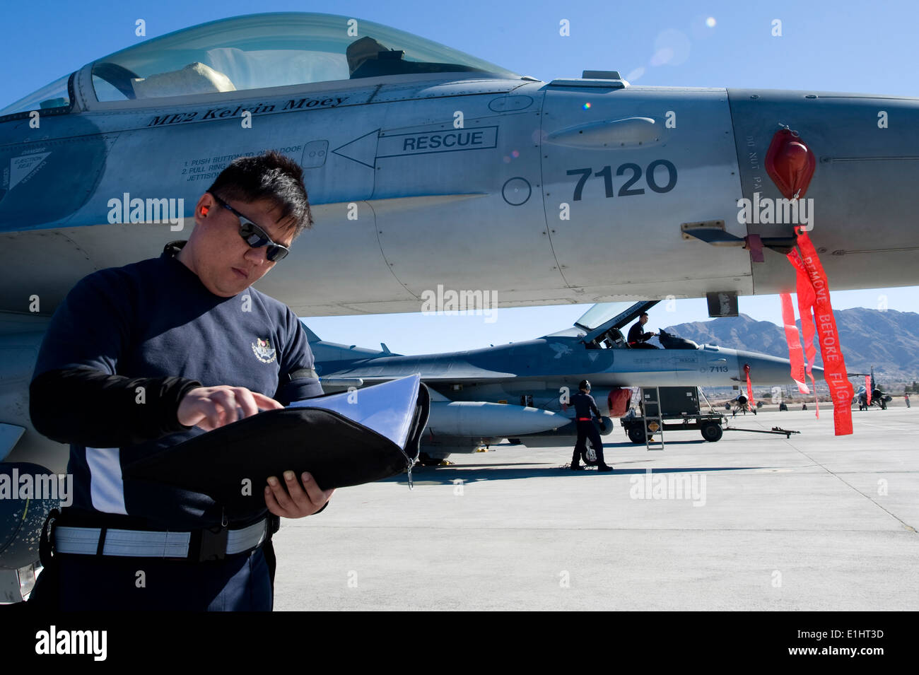 A Singapore Air Force airman reads a preflight checklist during Red ...