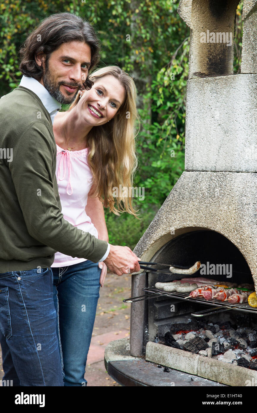 Couple standing grill man hi-res stock photography and images - Alamy