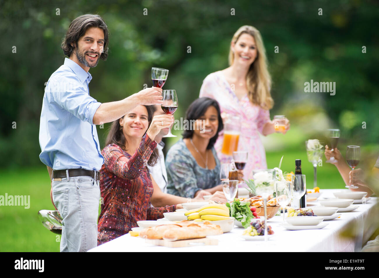 Man toasting with red wine on a garden party Stock Photo - Alamy