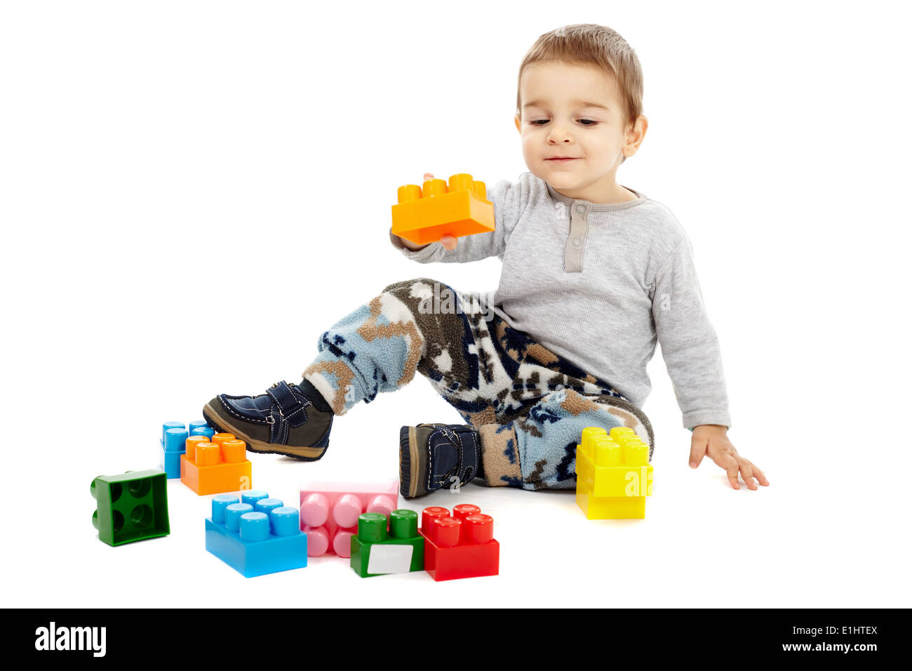Toddler boy playing with blocks, isolated on white background Stock ...