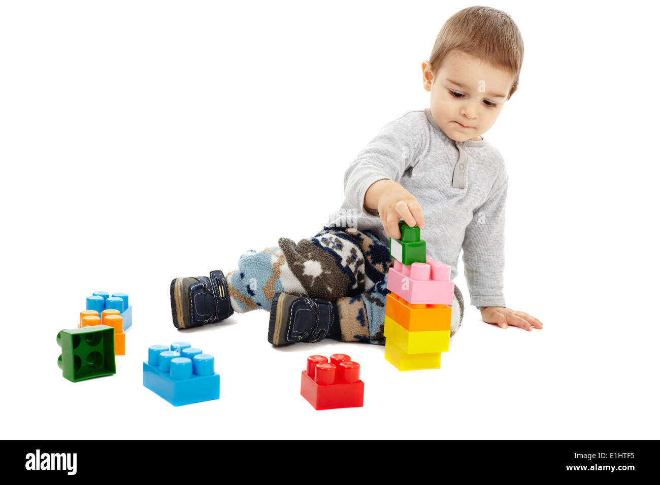 Toddler boy playing with blocks, isolated on white background Stock ...