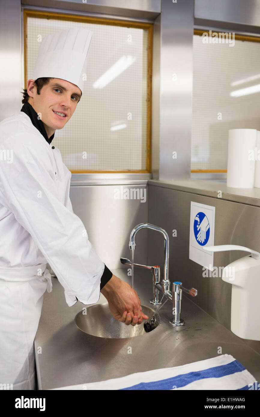 Cheerful chef washing hands Stock Photo - Alamy