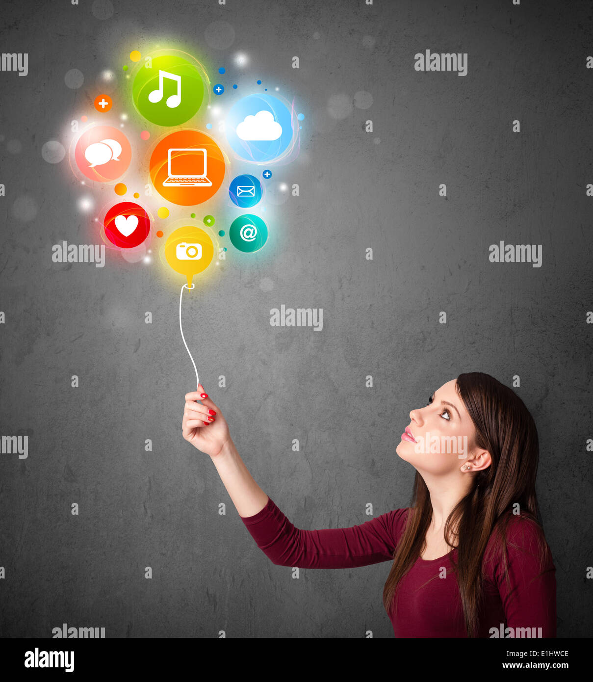 Woman holding social media balloon Stock Photo - Alamy