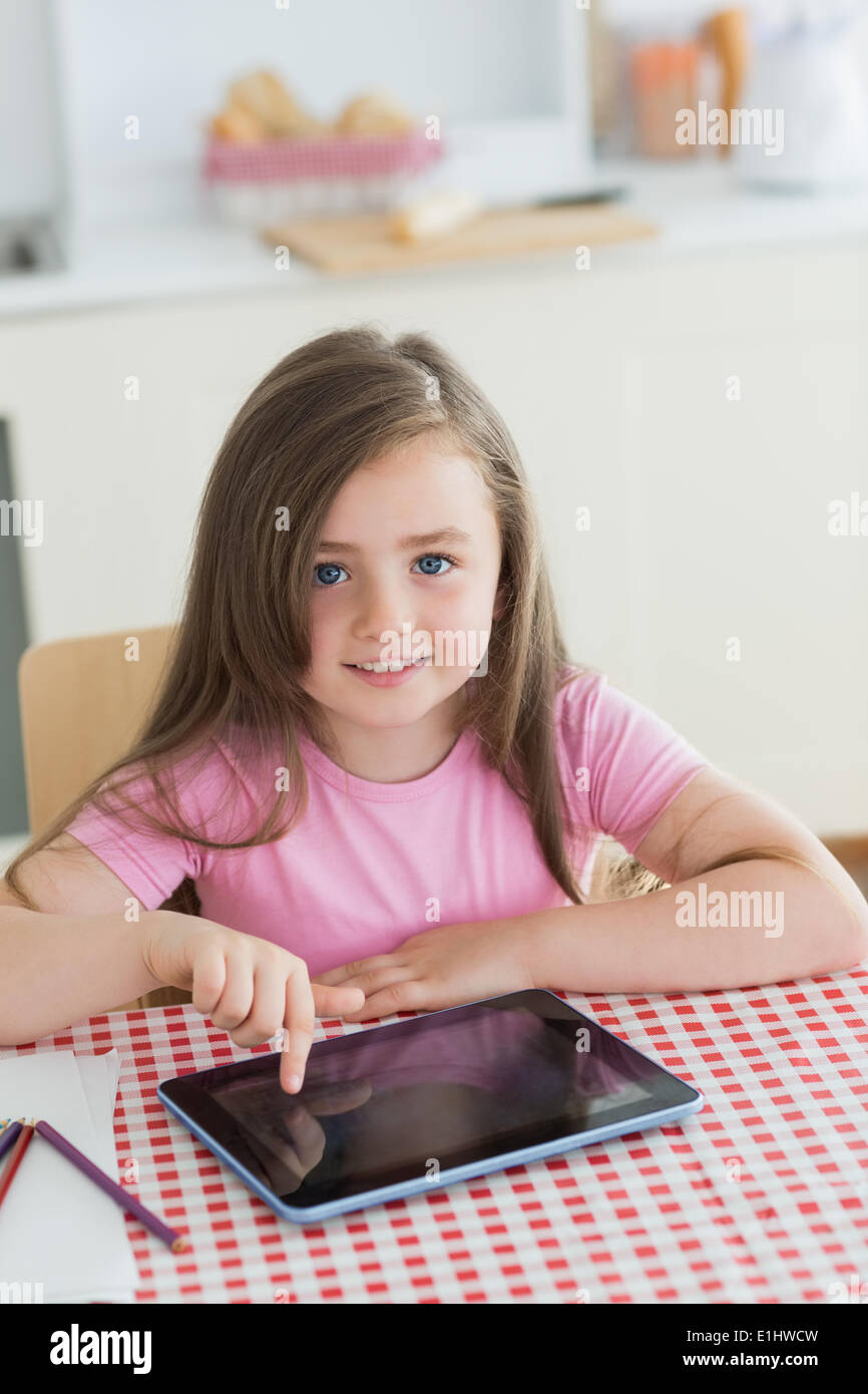 Happy little girl using tablet computer Stock Photo - Alamy