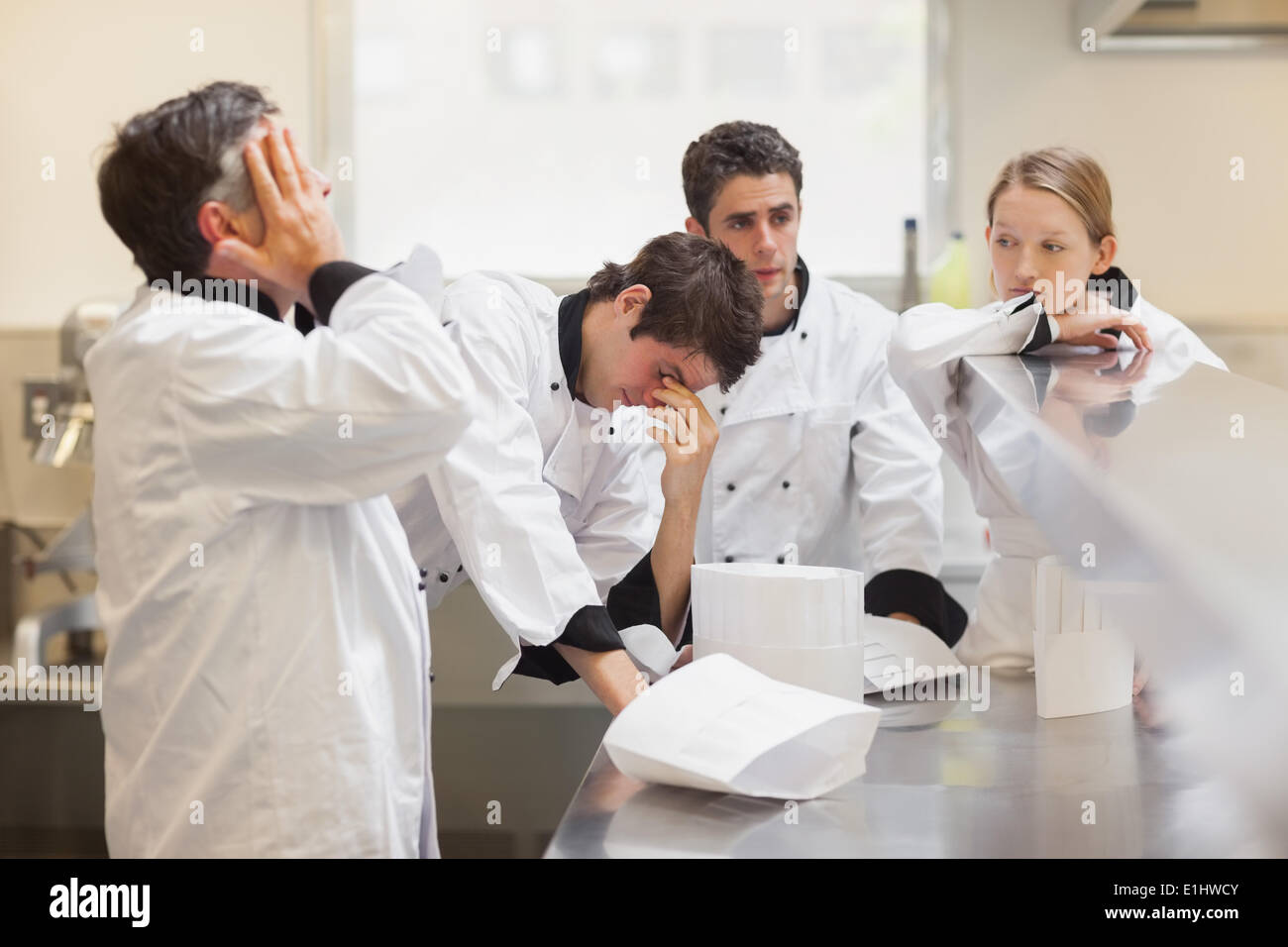 Exhausted team of chefs Stock Photo - Alamy