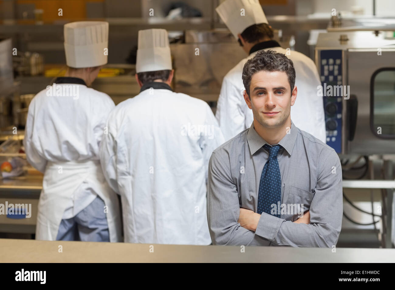 Waiter standing in the kitchen Stock Photo - Alamy