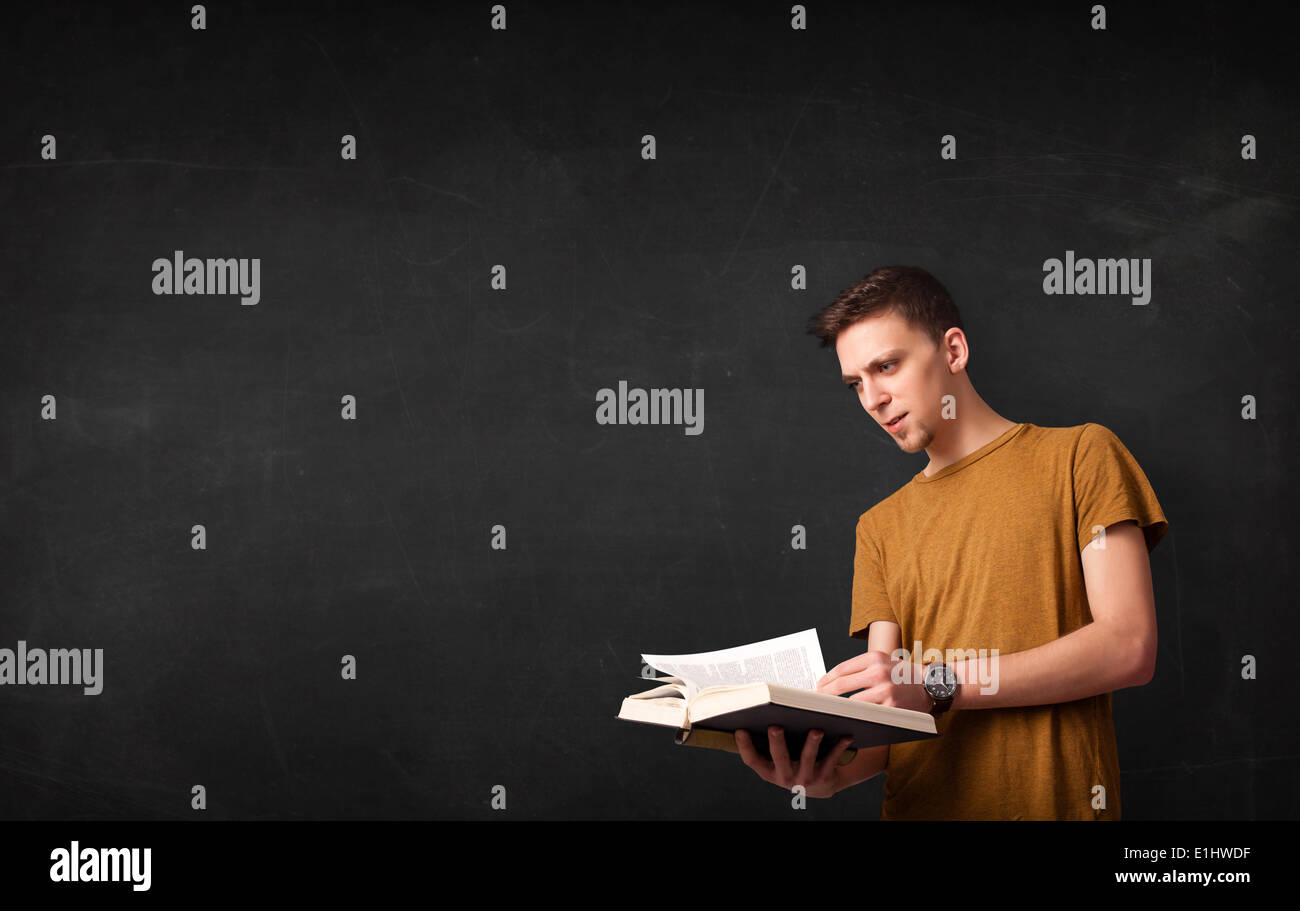 Young man reading a book Stock Photo - Alamy