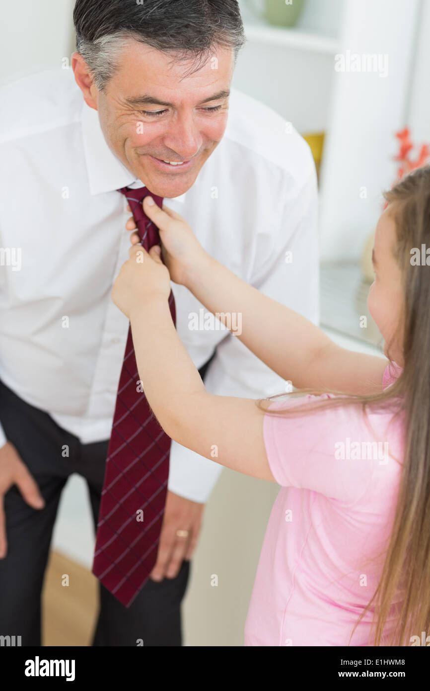 Father leaning down to let daughter fix tie Stock Photo - Alamy