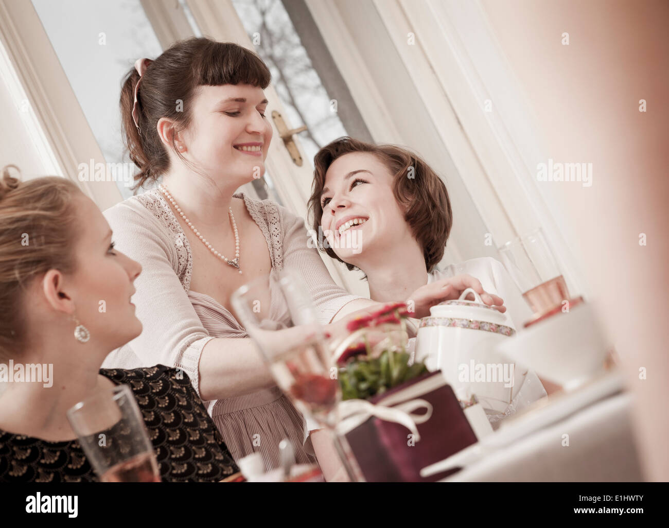 Young women on a retro style tea party Stock Photo - Alamy
