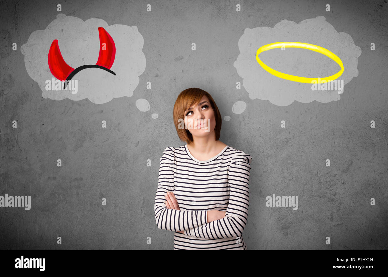 Woman choosing between good and bad Stock Photo - Alamy