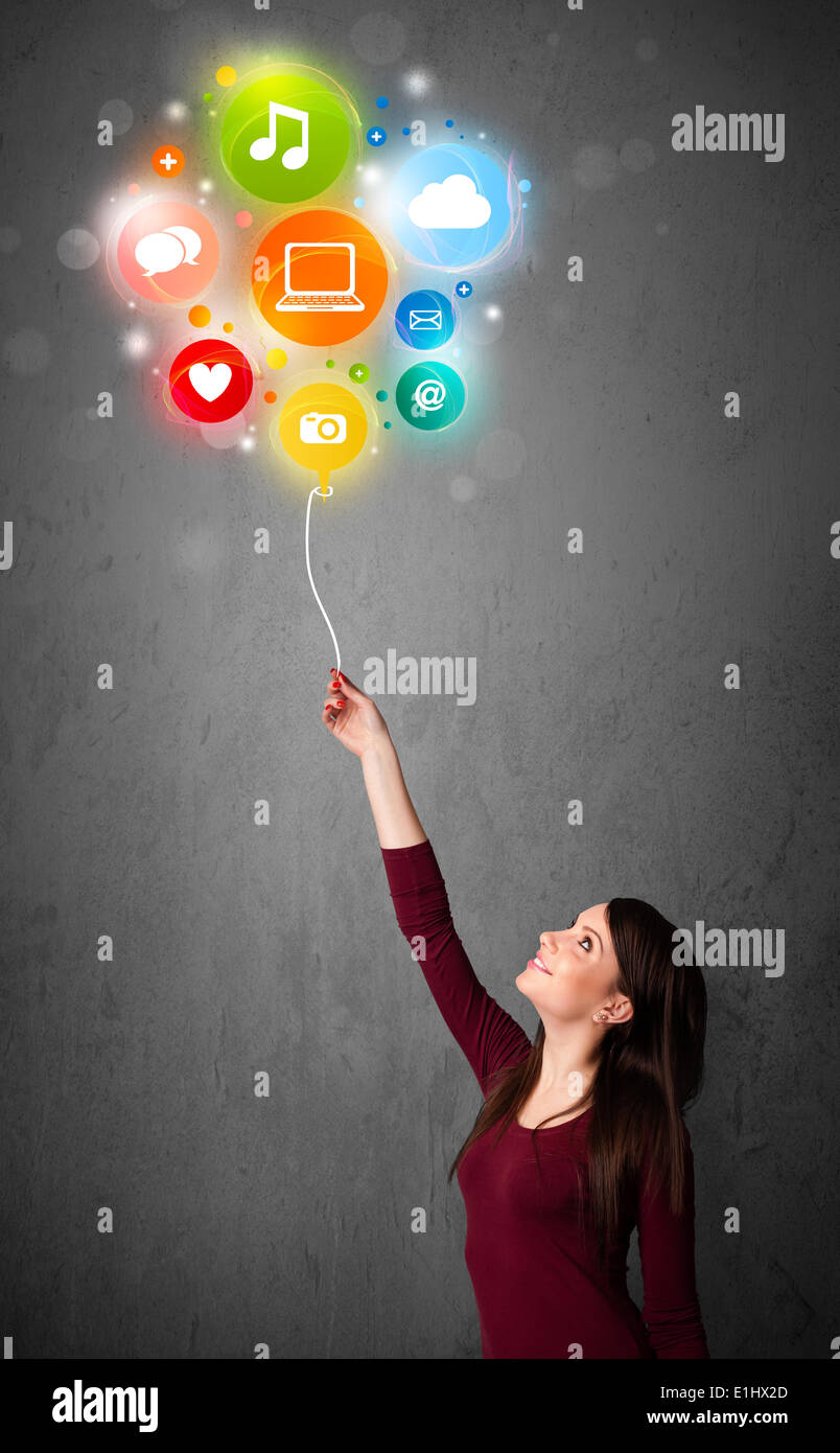 Woman holding social media balloon Stock Photo - Alamy