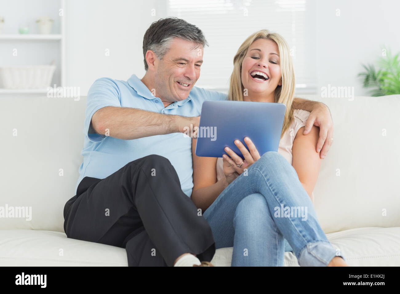 Husband and wife laughing at tablet pc Stock Photo - Alamy Husband and wife laughing at tablet pc Stock Photo - Alamy