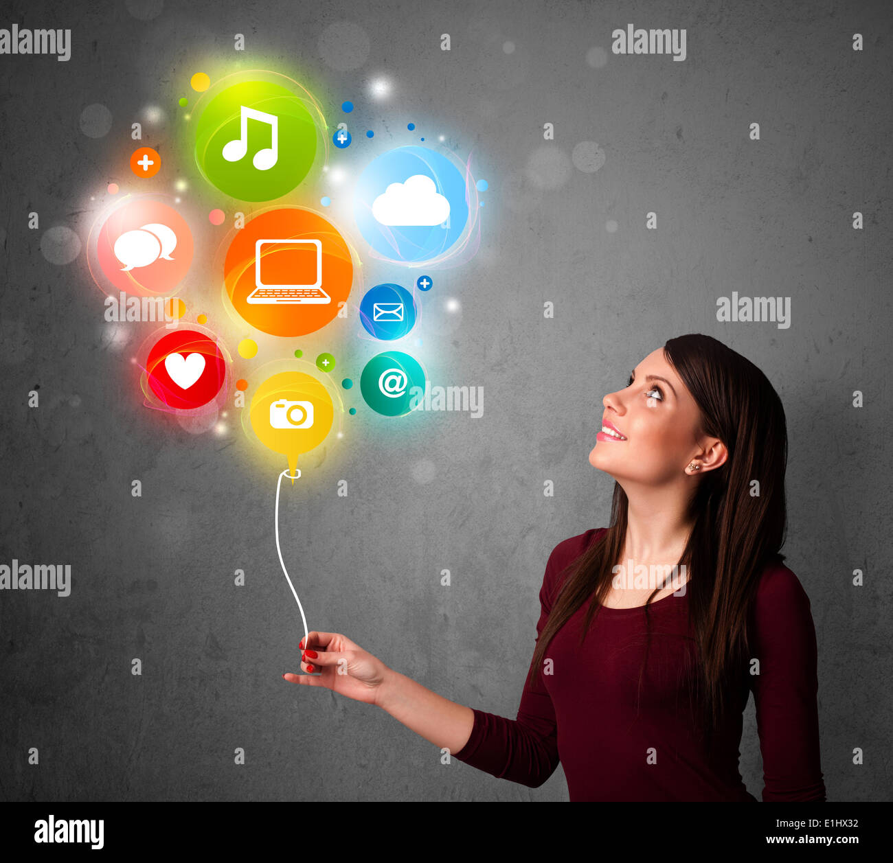 Woman holding social media balloon Stock Photo - Alamy